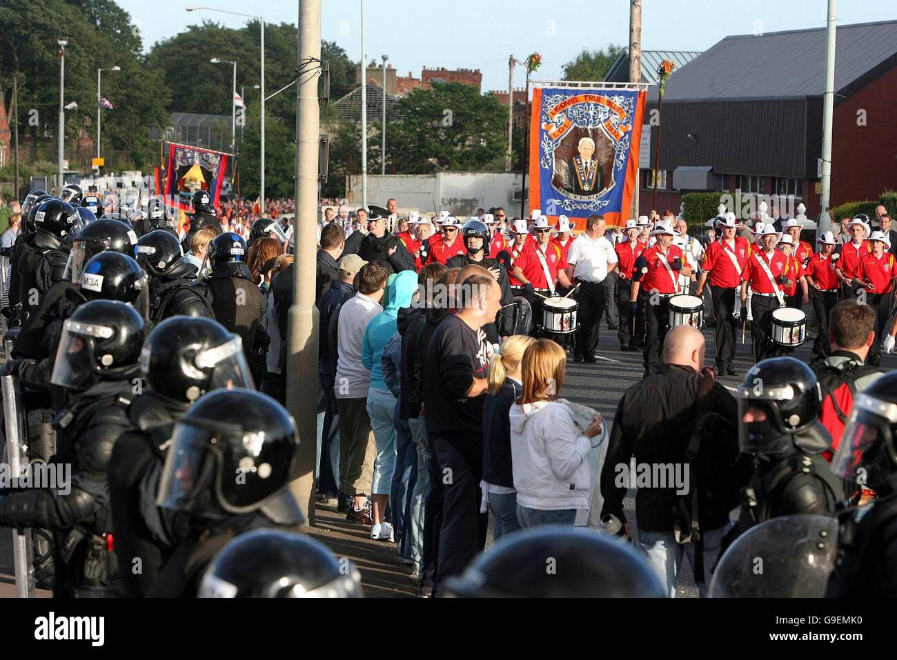 Police in riot gear escort Loyalist bands past the Nationalist Ardoyne ...