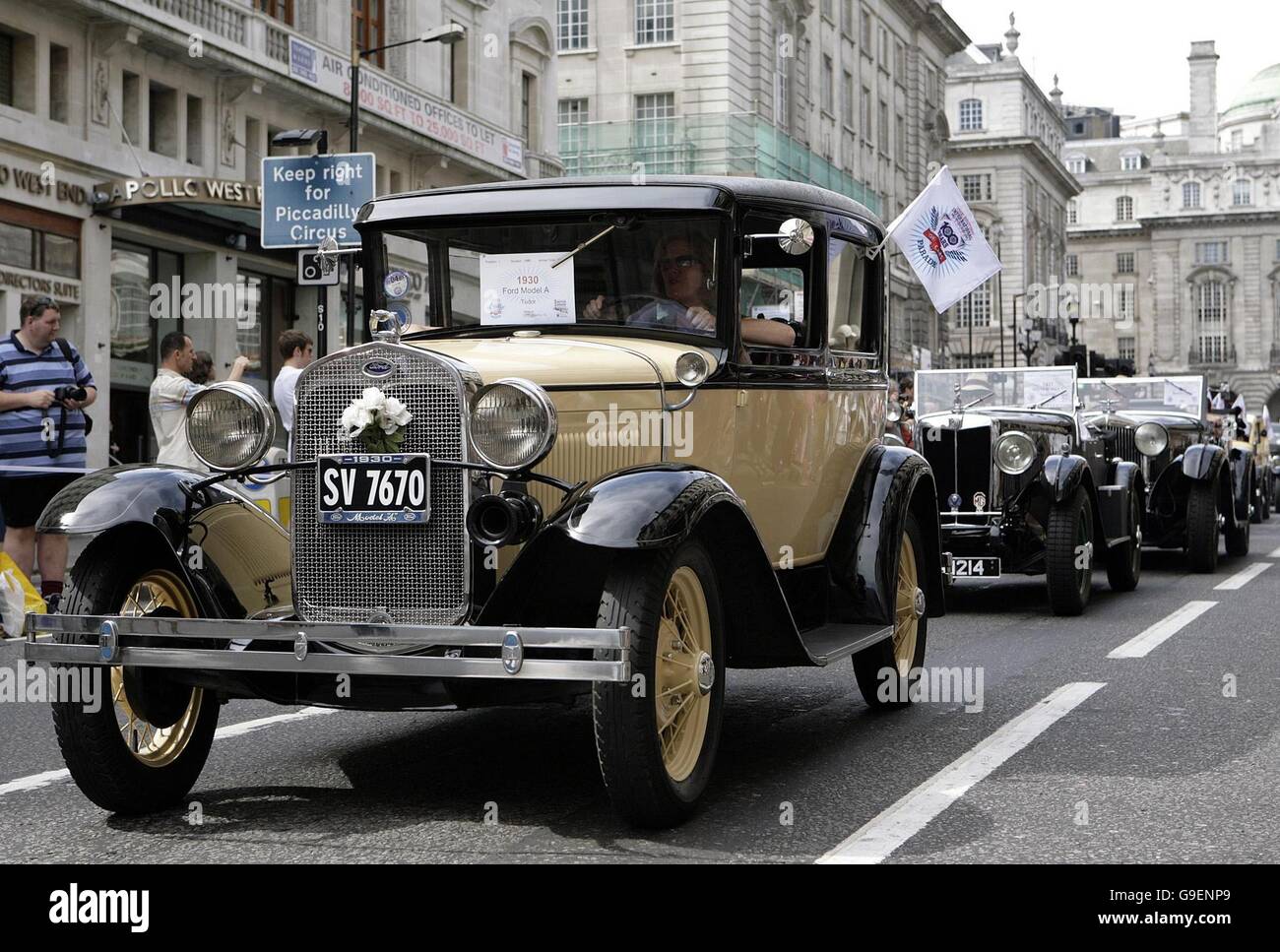 A 1930 Ford Model A is driven in a parade showcasing 100 years of cars ...