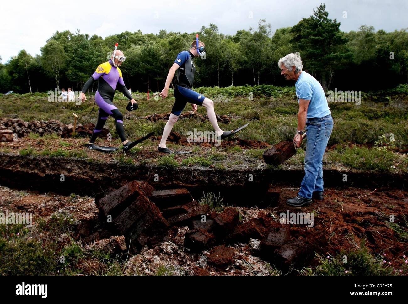 A turf cutter at work as two competitors walk past to take part in the ...