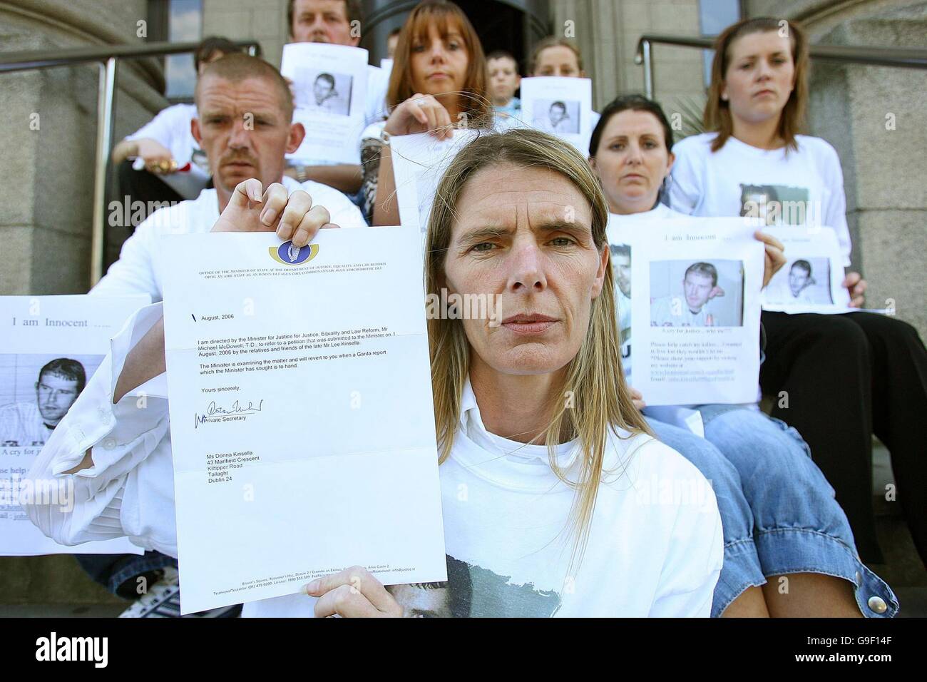 Donna Kinsella, whose brother was murdered in May, holds a letter from ...