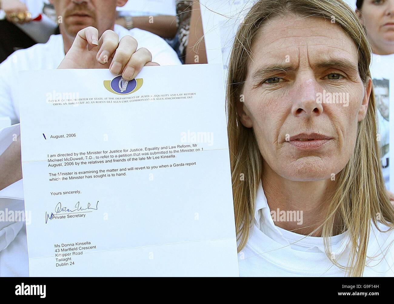 Donna Kinsella, whose brother was murdered in May, holds a letter from ...