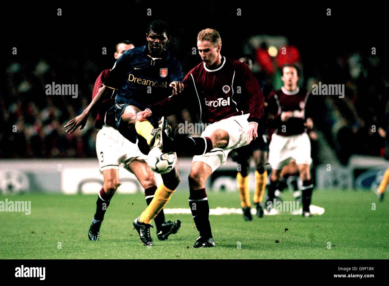Pragues rene bolf tries to clear from arsenals nwankwo kanu hi-res ...