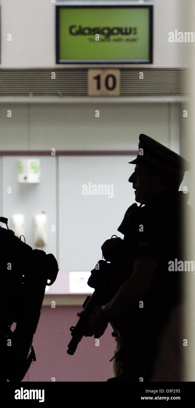 Armed police patrol inside the terminal building at Glasgow Airport ...