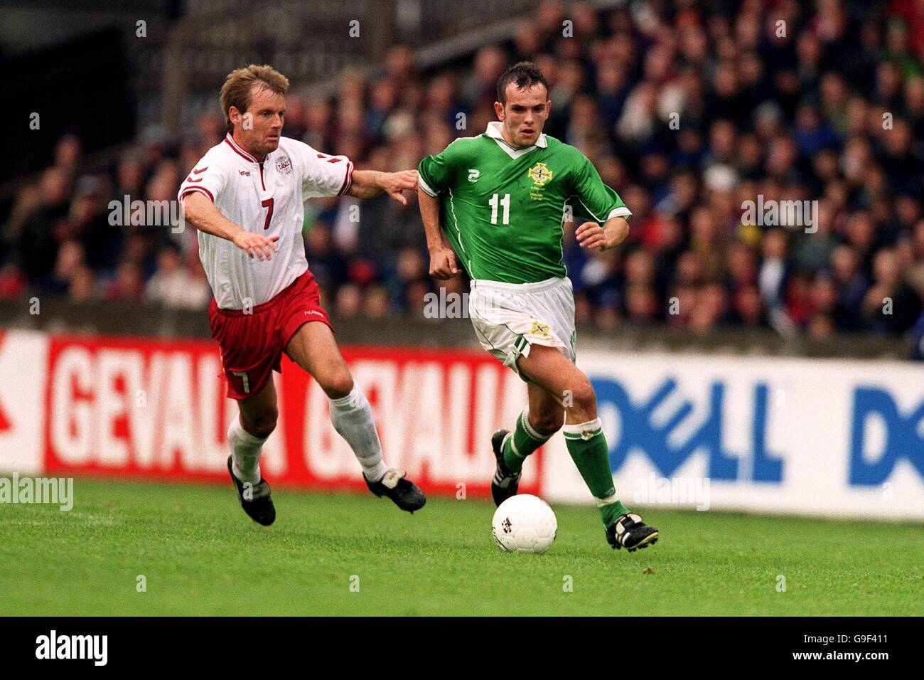 Northern Ireland's Stuart Elliot (r) is tracked by Denmark's Brian ...