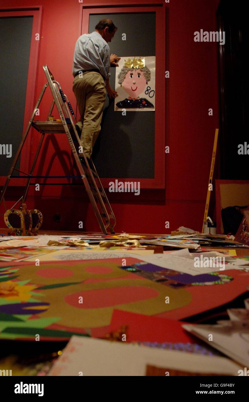 Exhibition designer George Carter hanging one of the many 80th birthday ...