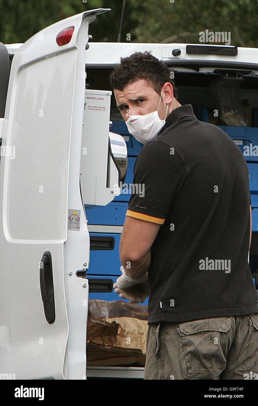 A Crime Scene Police officer gathering evidence at a cordoned house in ...