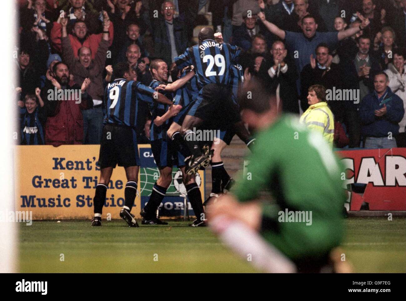 Gillingham's Barry Ashby is mobbed by teammates after scoring the ...
