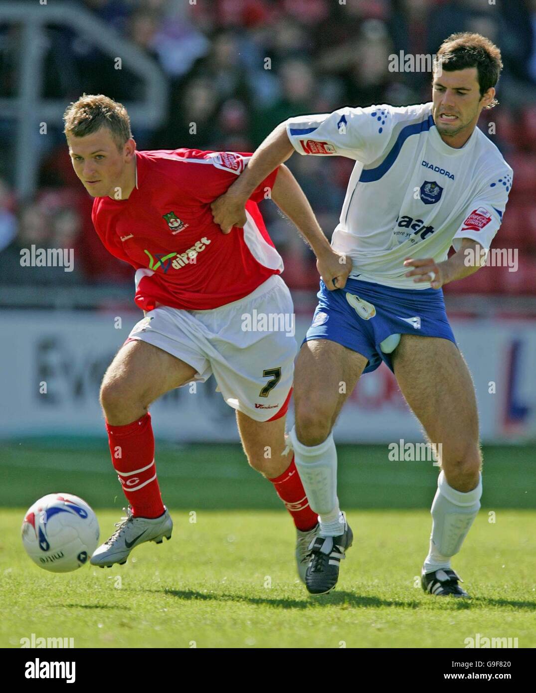 Wrexham's Mark Jones, left, gets to grips with Peterborough's Richard ...