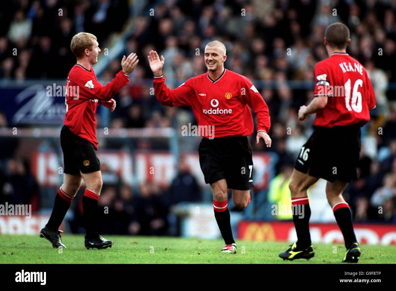 David beckham celebrates his goal with roy keane hi-res stock ...