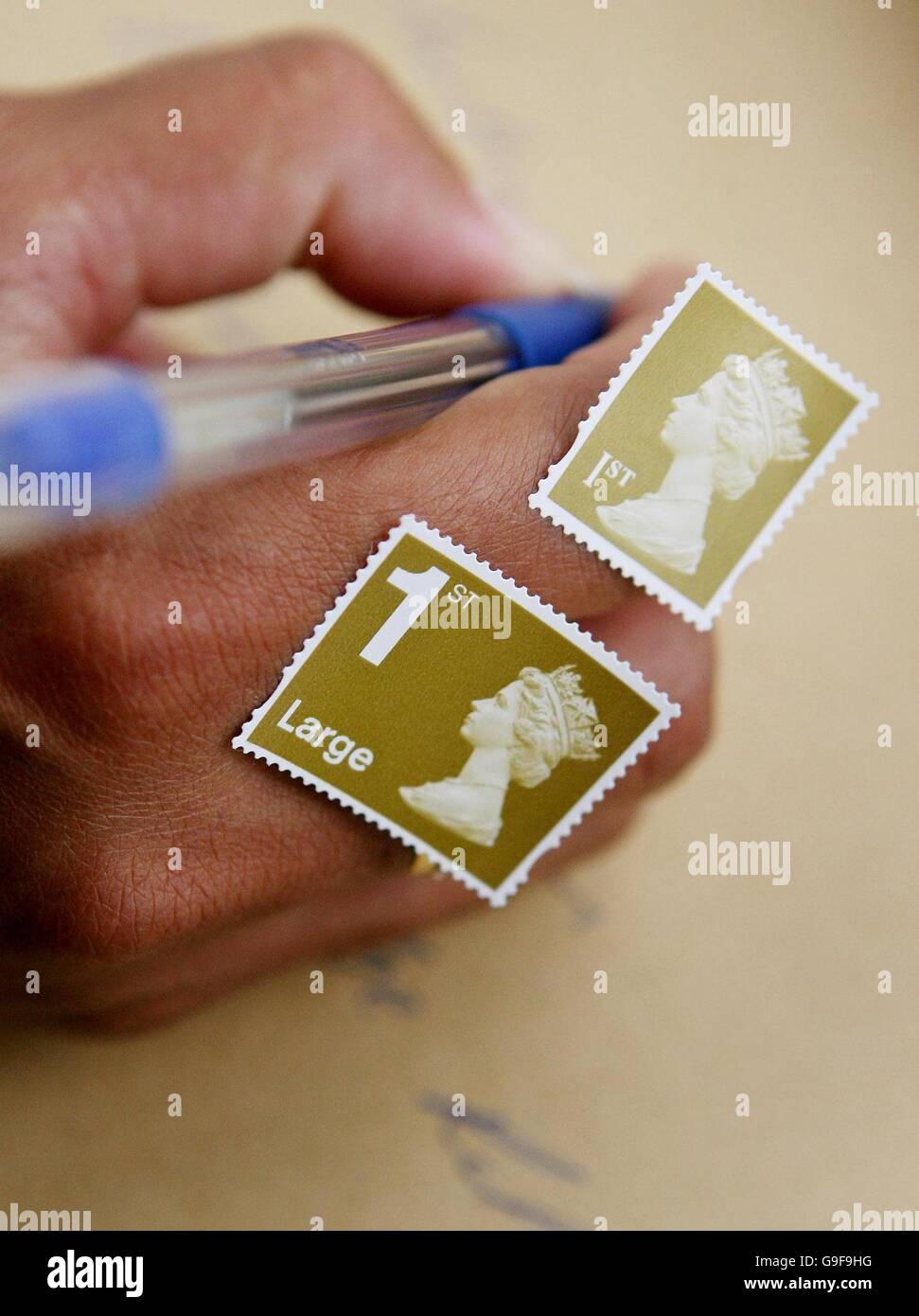 Two different-sized stamps are prepared for use on a letter, in Ashford ...