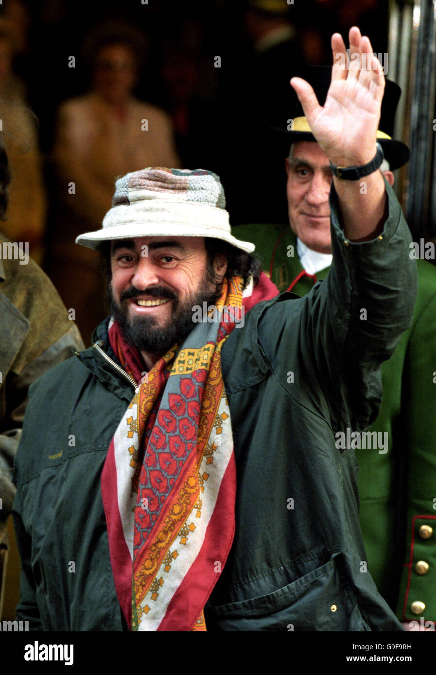 Italian tenor Luciano Pavarotti waves to his fans as he arrives at ...