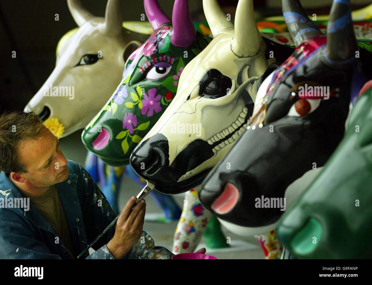 Nial Smith, an artist for Edinburgh's CowParade, adding the finishing ...
