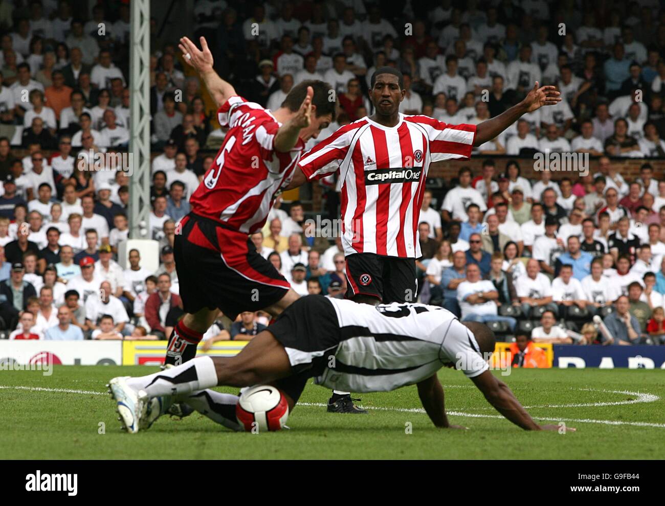Fulham's Collins John is brought down by Sheffield United's Chris ...
