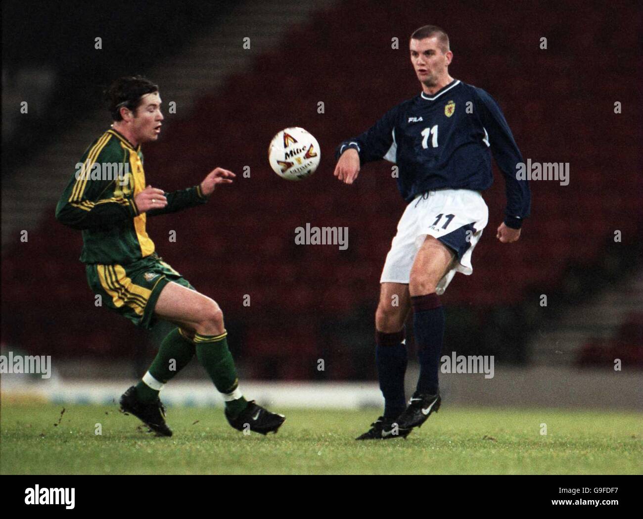 Scotland's Dominic Matteo (r) is closed down by Australia's Brett ...