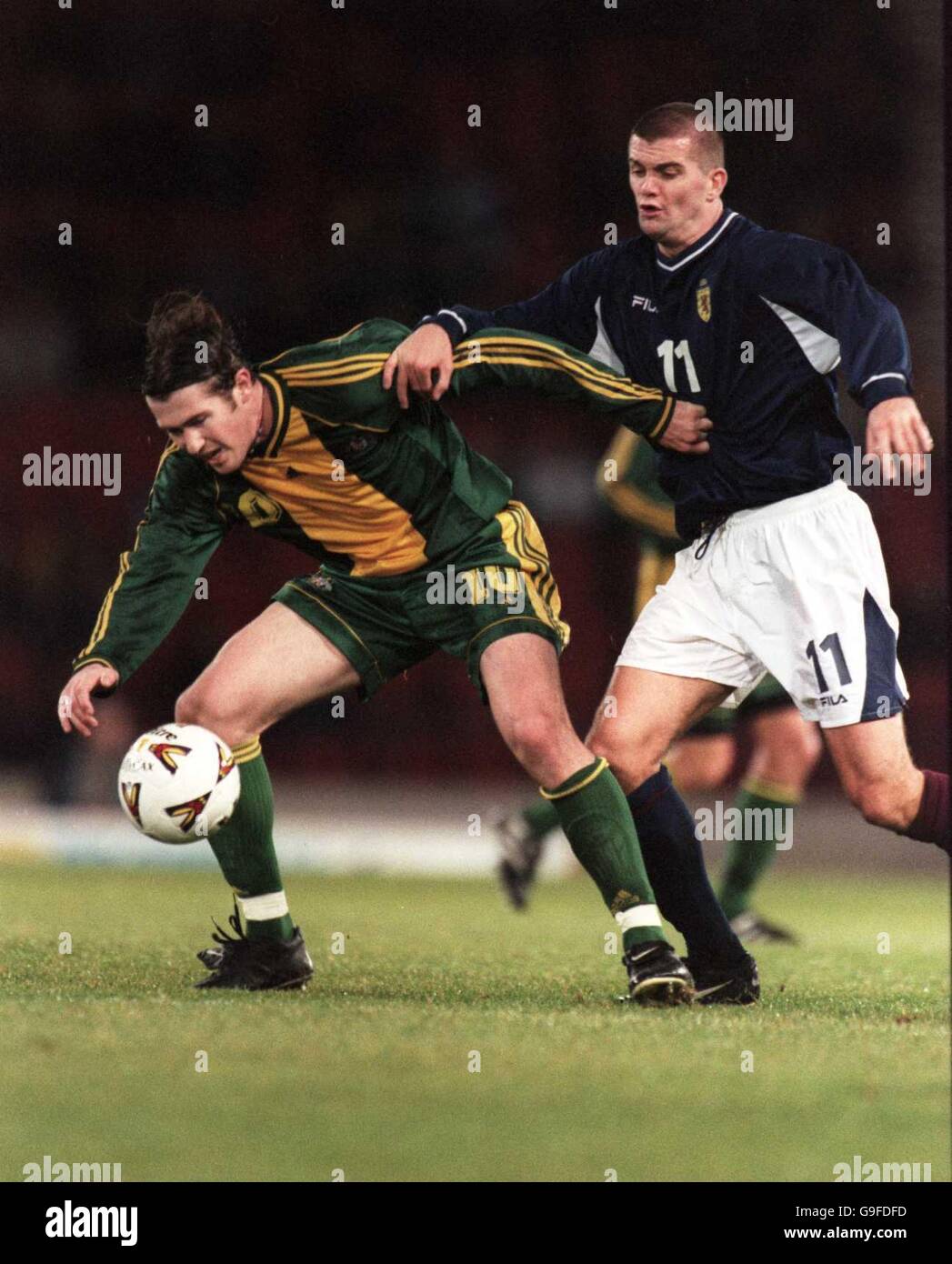 Scotland's Dominic Matteo (r) puts pressure on Australia's Brett ...