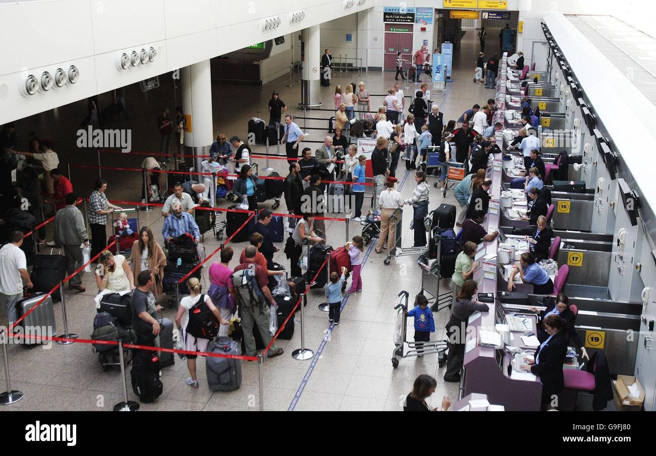 People queuing at the check in area inside the terminal building at ...
