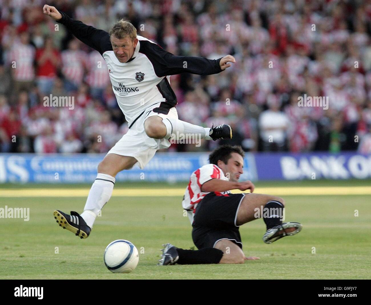 Gretna's Steve Tosh (left) challenges Derry City's Kevin Deery during ...