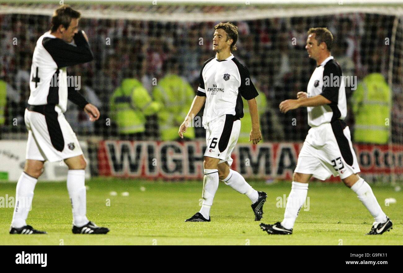 Gretna's Chris Innes (centre) looks dejected following their 5-1 defeat ...