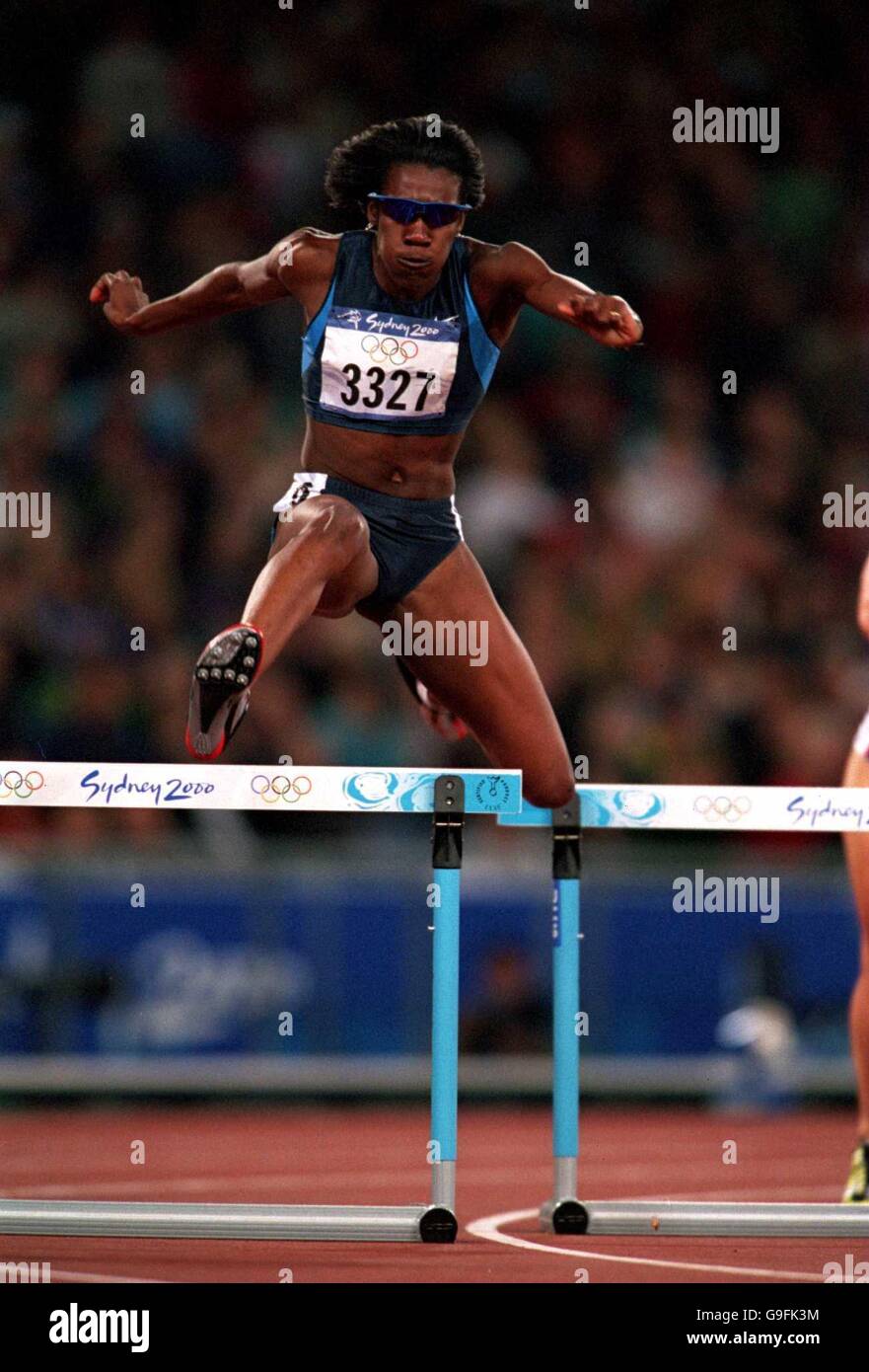 USA's Kim Batten flies over the hurdles to qualify for the next round ...
