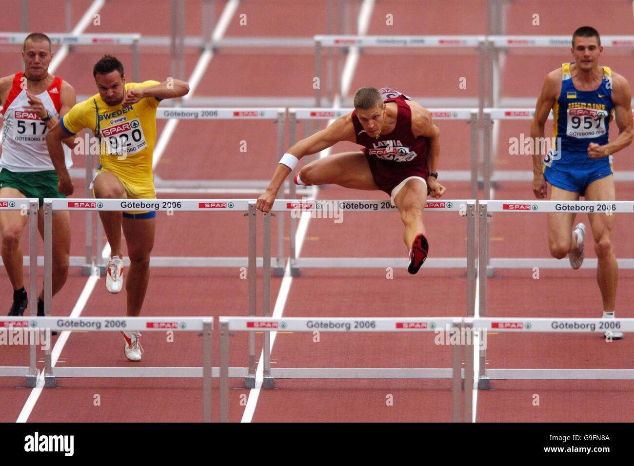 Athletes compete on the mens 110 metre hurdles hi-res stock photography ...