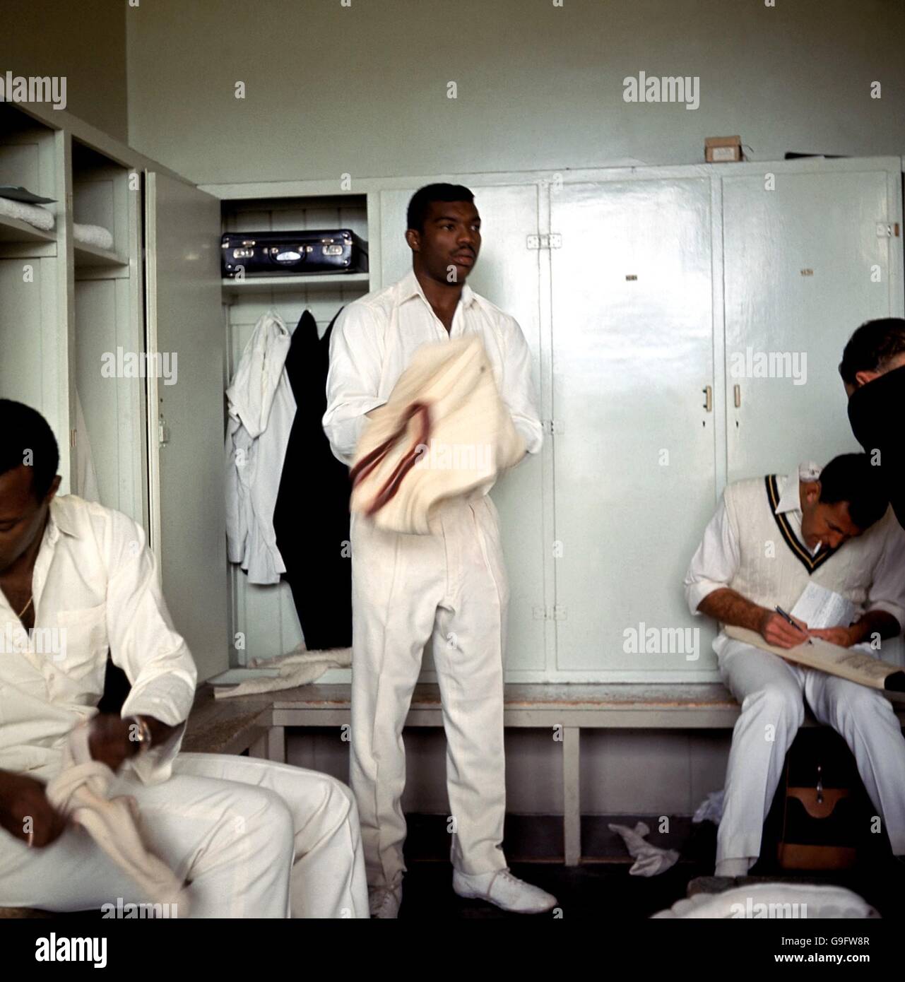 West Indies star Charlie Griffith pulls on his sweater in the dressing ...