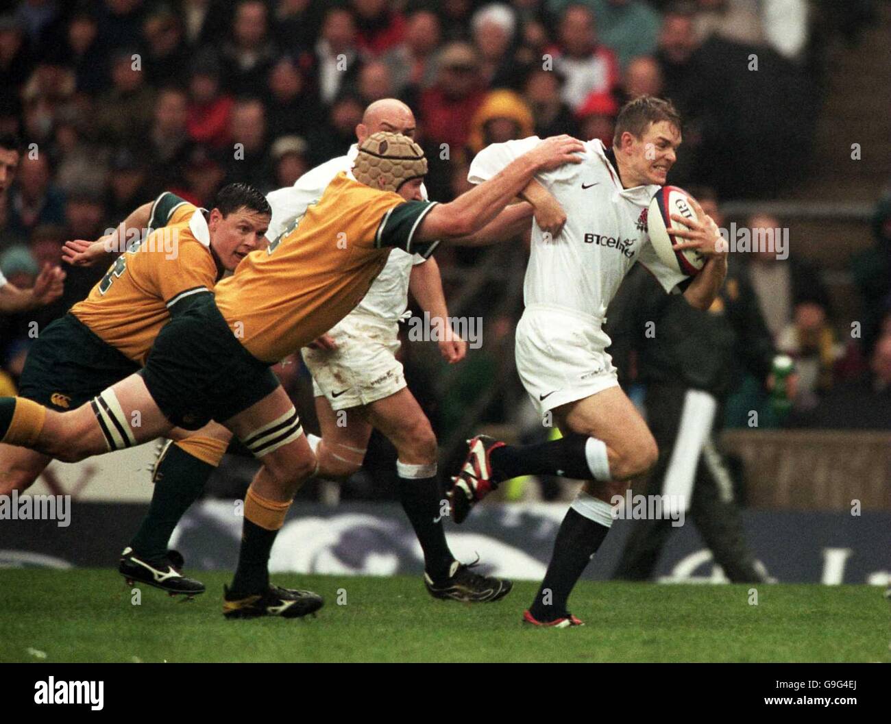 England's Matt Perry shrugs off the tackle of Australia's David Giffin ...
