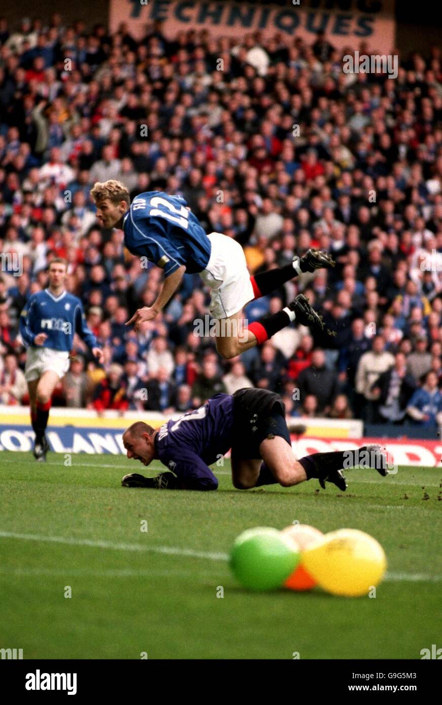Rangers' Tore Andre Flo (top) goes flying over Celtic goalkeeper Robert ...