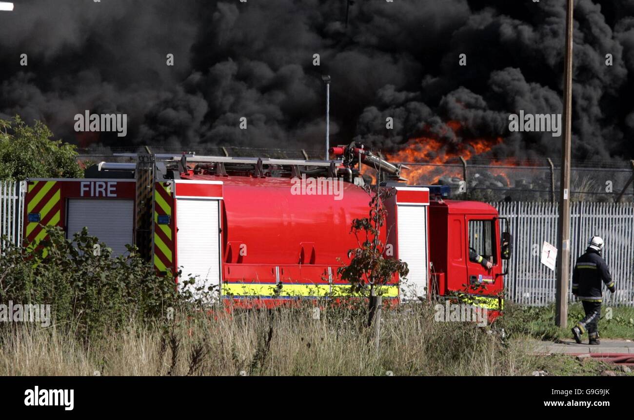 Tyres on fire at a scrapyard dump next to Stanlow Oil Refinery at ...