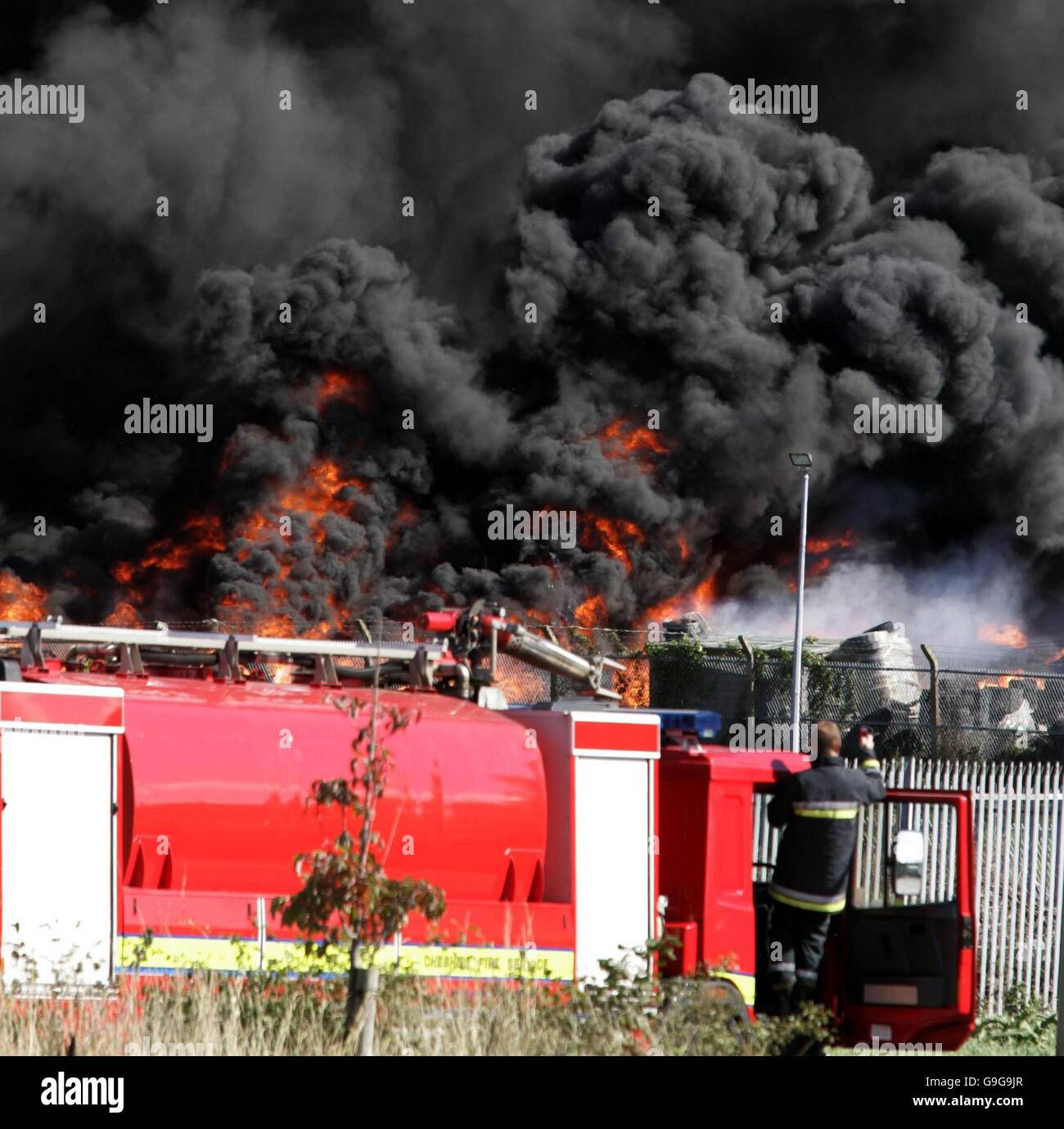 Tyres on fire at a scrapyard dump next to Stanlow Oil Refinery at ...