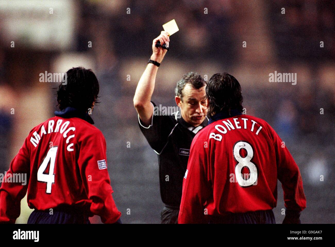 Referee Willie Young shows the yellow card to Dundee's player manager ...