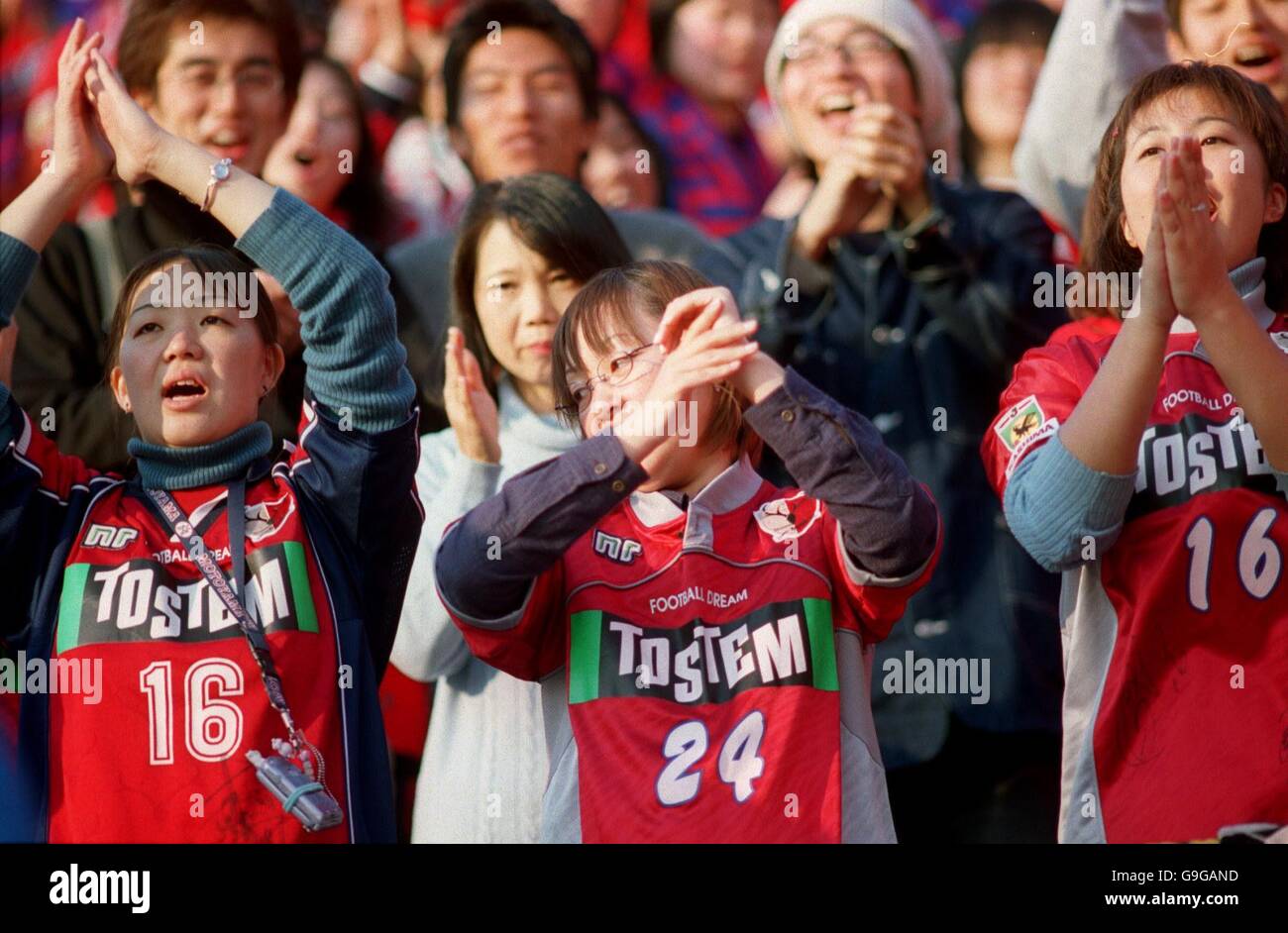 Three female kashima antlers fans cheer on their side hi-res stock ...