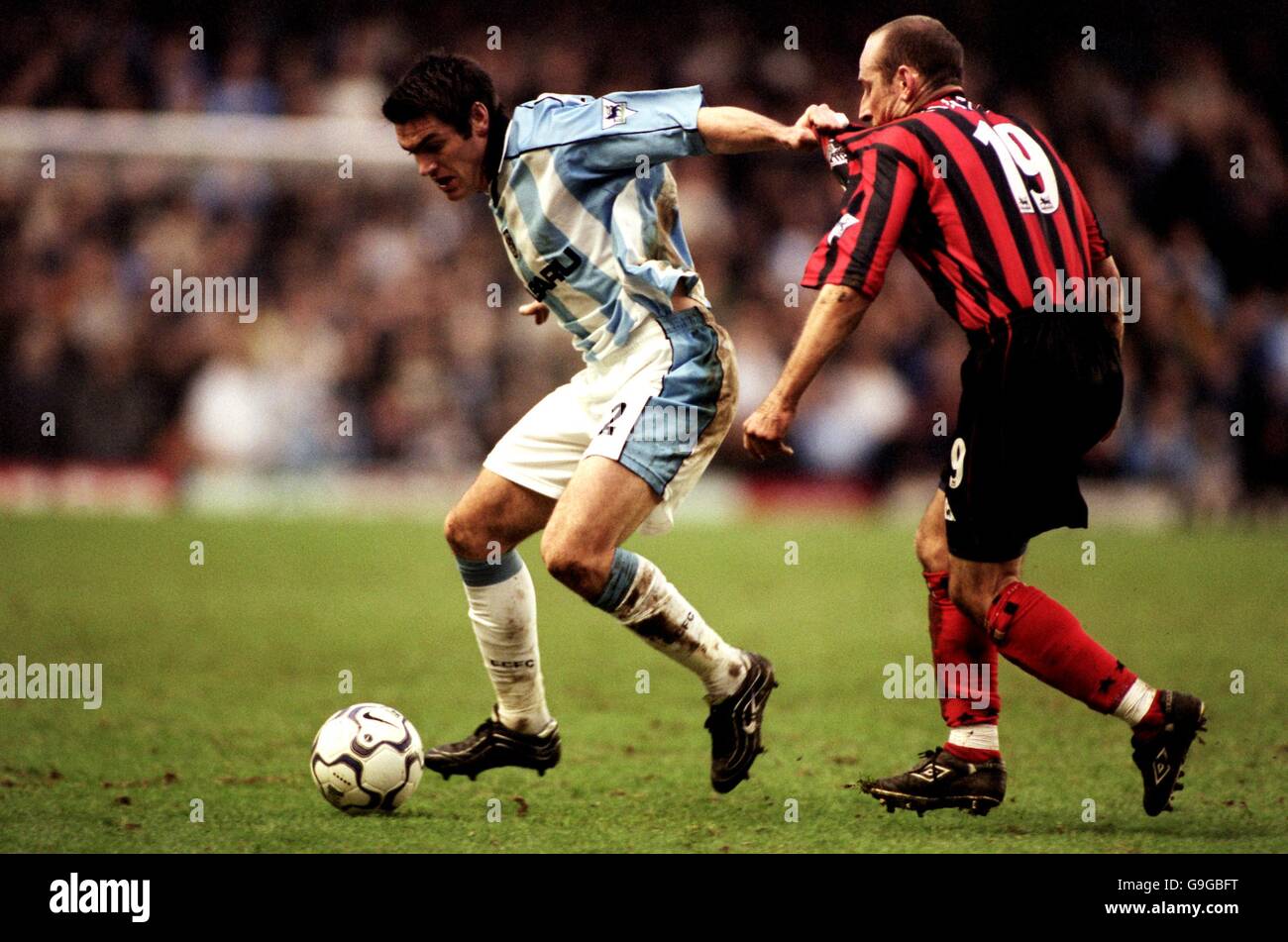 Coventry City's Marc Edworthy (l) pulls the shirt of Manchester City's ...