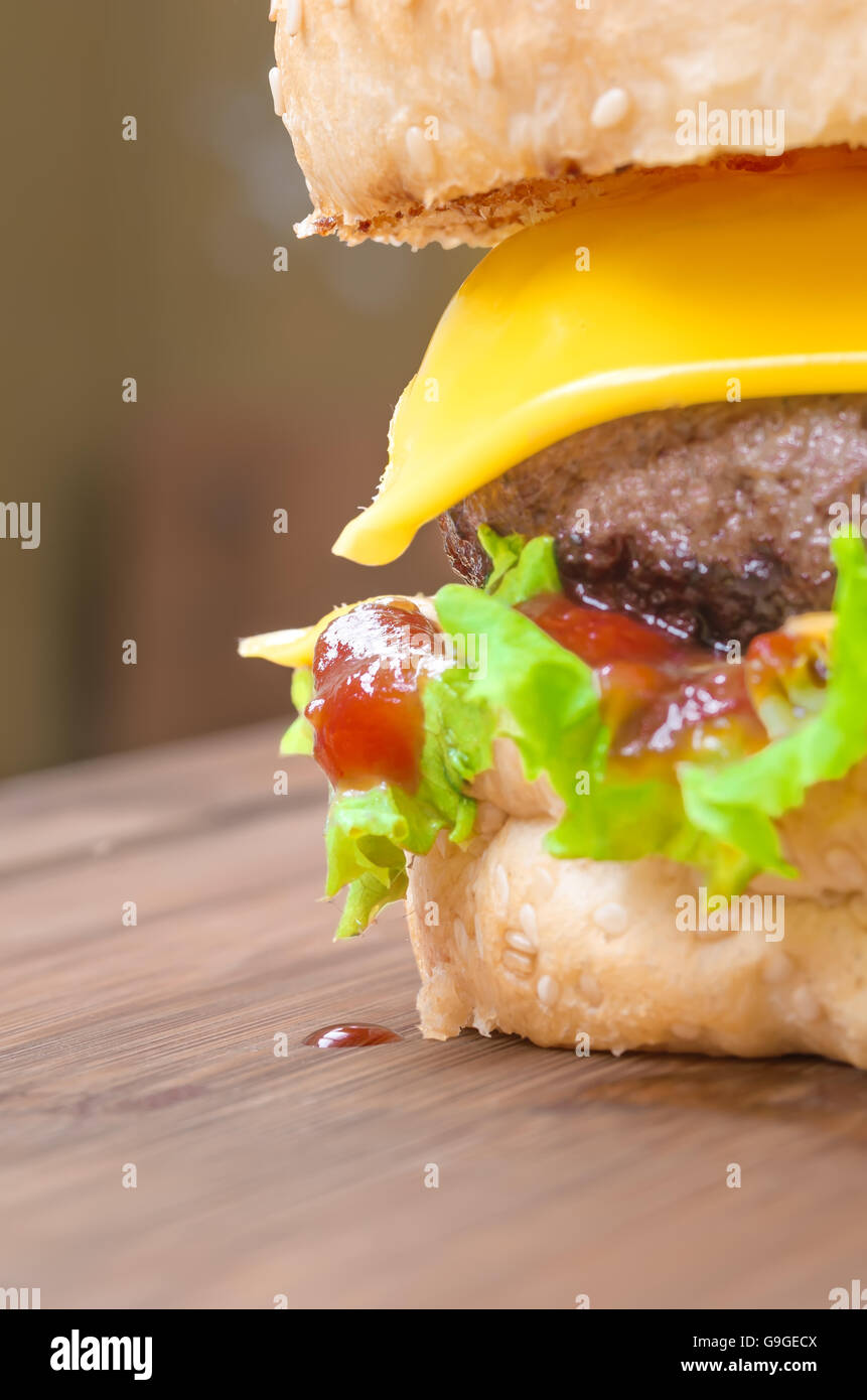 Tasty cheeseburger on wooden table, food photography Stock Photo - Alamy