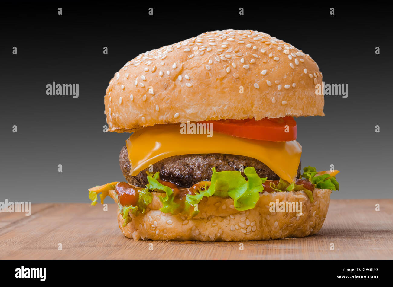 Tasty cheeseburger on wooden table, food photography Stock Photo - Alamy