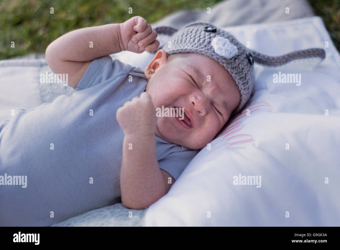 A newborn baby girl sleeping in the garden, crying Stock Photo - Alamy