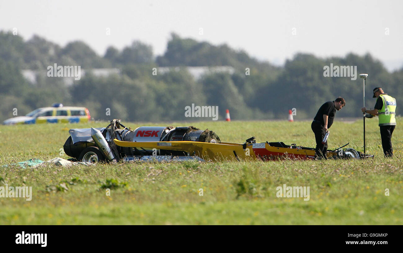 Police officers examine the car that Top Gear presenter Richard Hammond crashed in, at Elvington ...