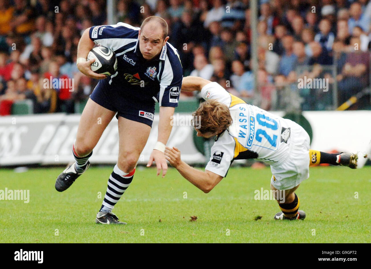 Bristol's Shaun Perry breaks through a tackle from Wasps' Simon Amor ...