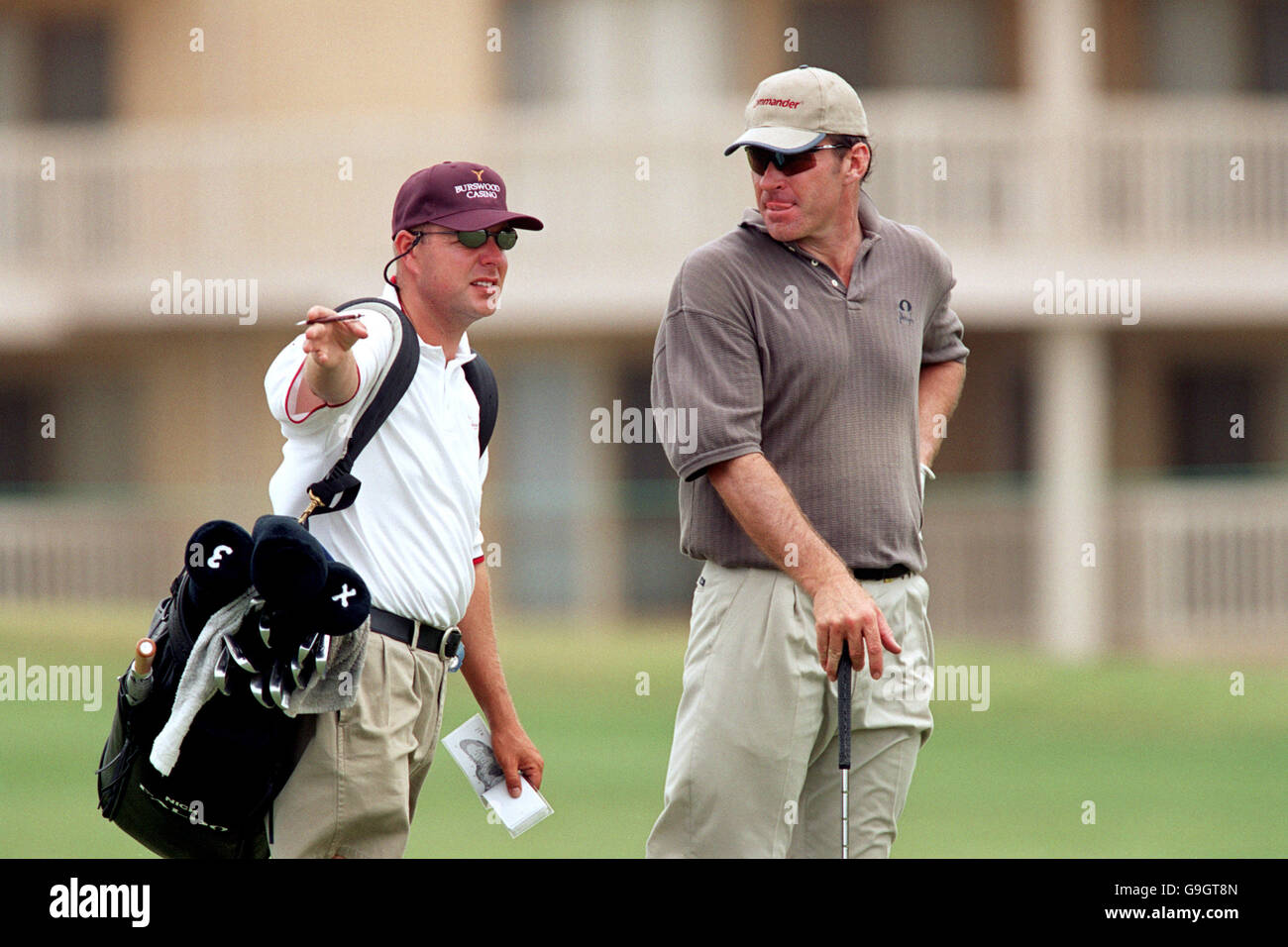 Nick Faldo chats with his caddie on the 18th green during the Pro-Am ...
