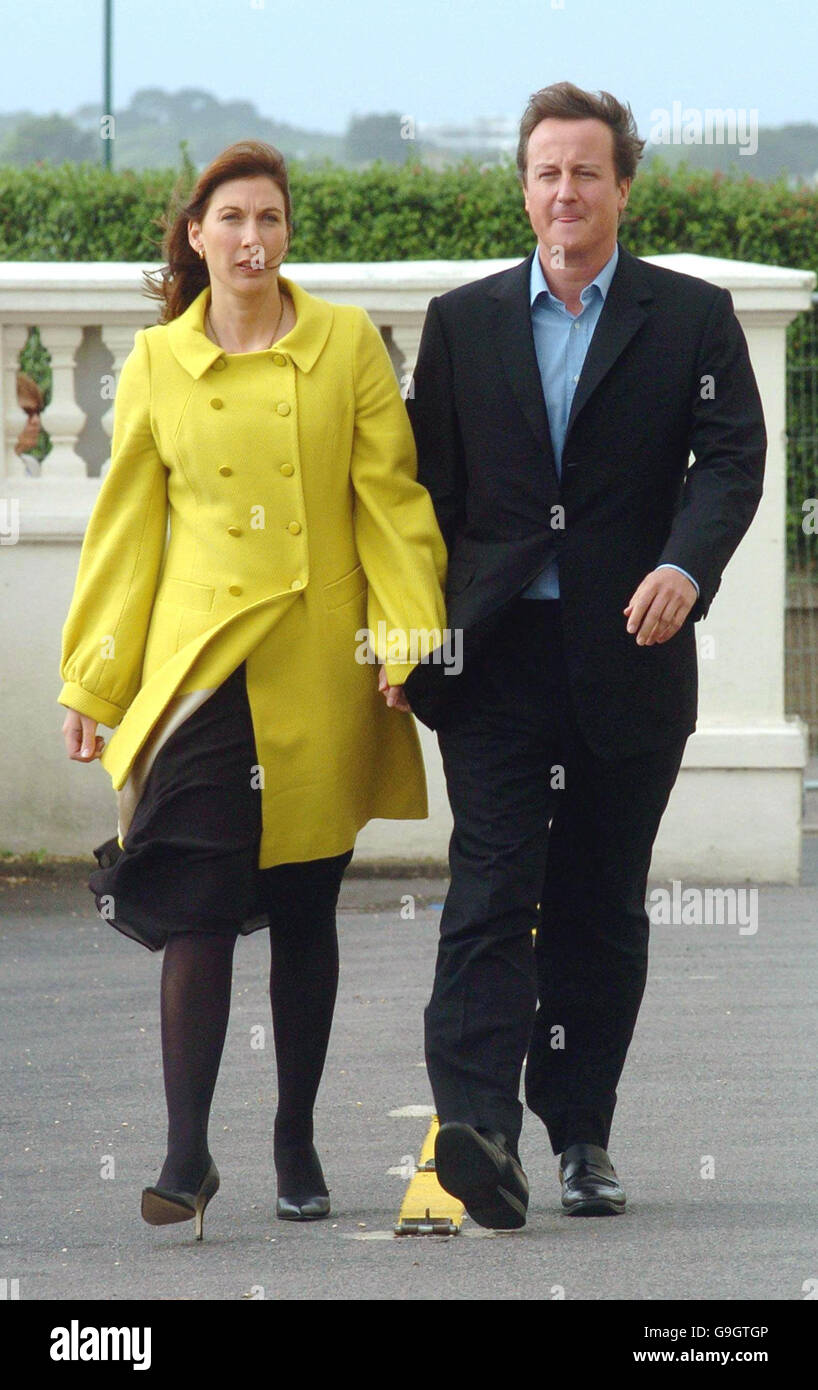 Conservative Party leader David Cameron arrives with his wife Samantha ...