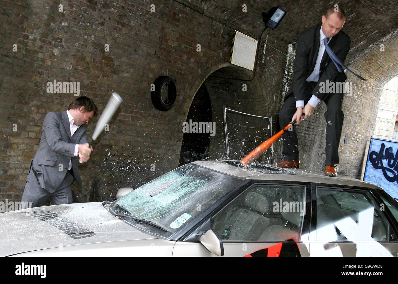 Office workers armed with baseball bats take out their stress on scrap ...