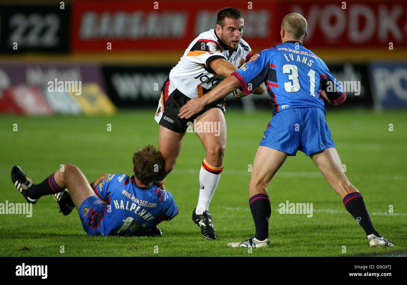 Bradford's Andy Lynch is tackled by Wakefield's Colum Halpenny and ...