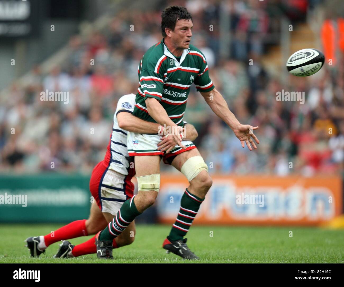 Leicester's Martin Corry gets his pass away as he is tackled during the ...
