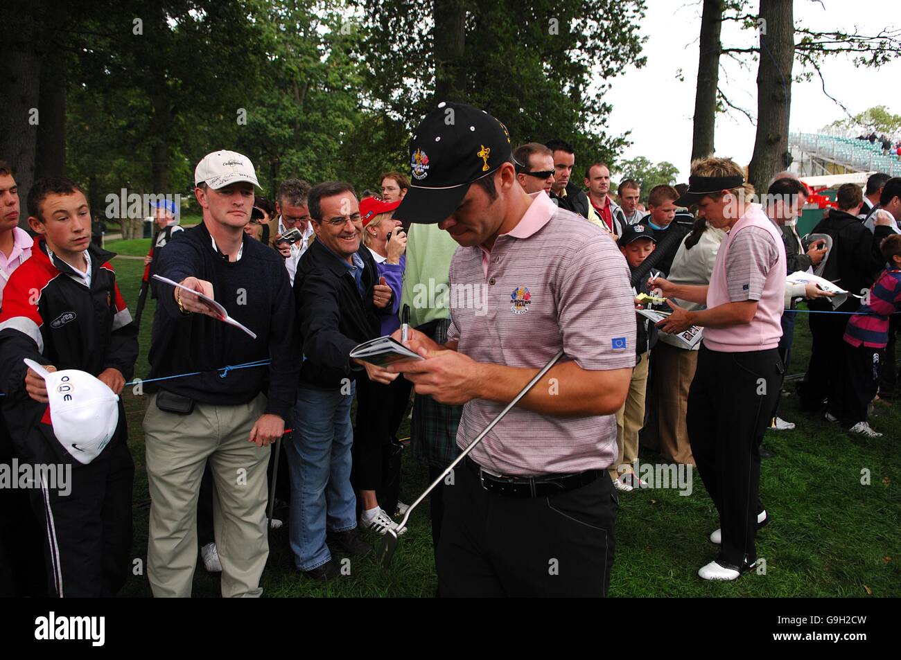 Europe's Paul Casey (l) and teammate Luke Donald sign autographs during ...