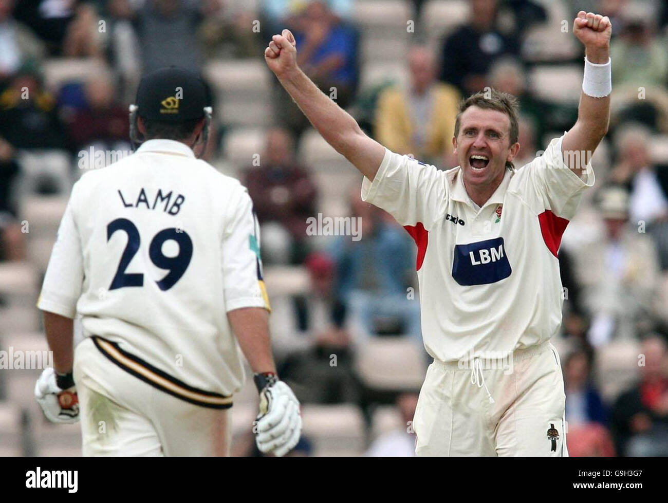 Lancashire's Dominic Cork (right) celebrates taking the wicket of ...