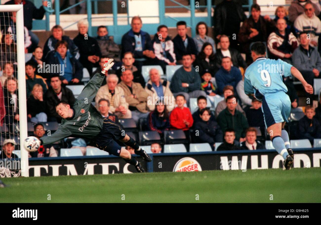 Arsenal goalkeeper Graham Stack (l) stretches for the ball as Coventry ...