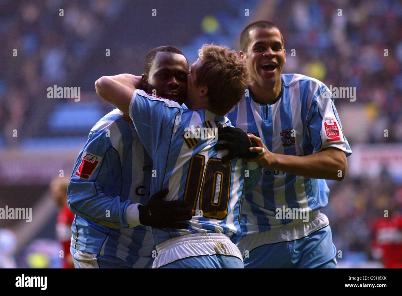 Coventry City's Stern John celebrates scoring with team mates Gary ...