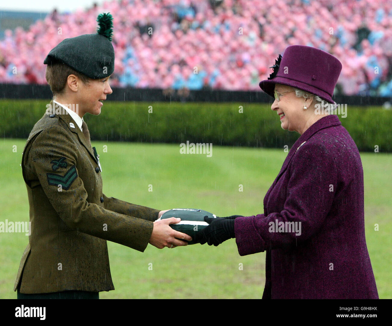 Britain's Queen Elizabeth II presents Coporal Claire Withers, with the ...