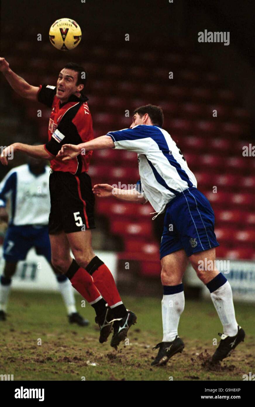 Walsall's Andy Tilson heads the ball away from Bury's Steve Redmond ...