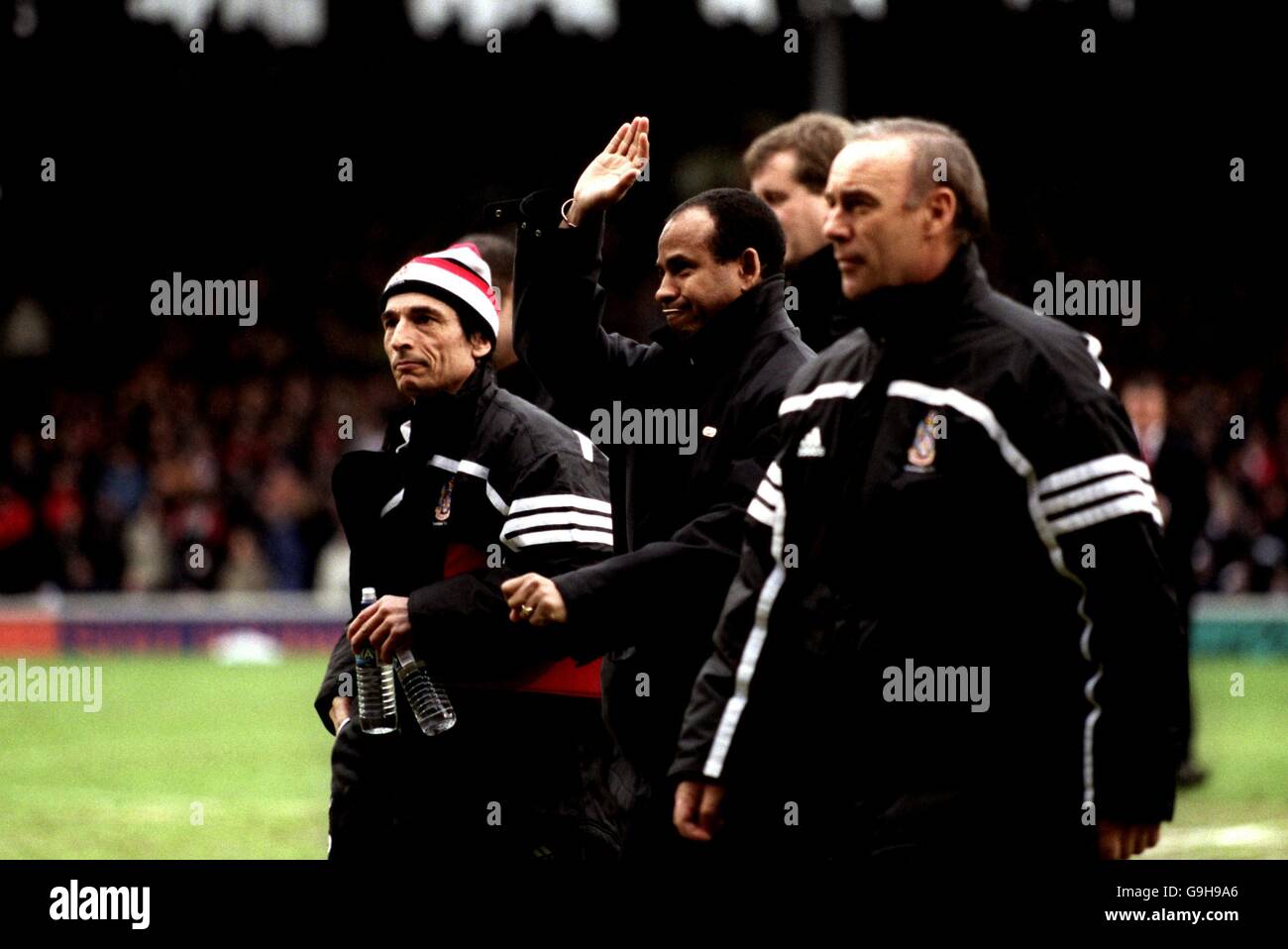 Fulham manager Jean Tigana waves to the crowd with his assistant ...