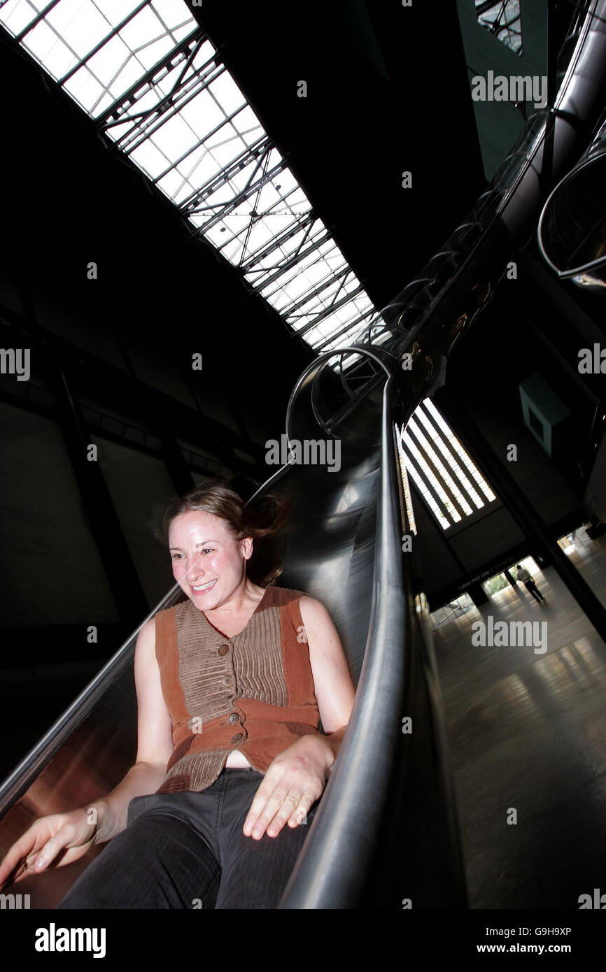 A visitor to the Tate Modern in London rides on one of the, newly ...